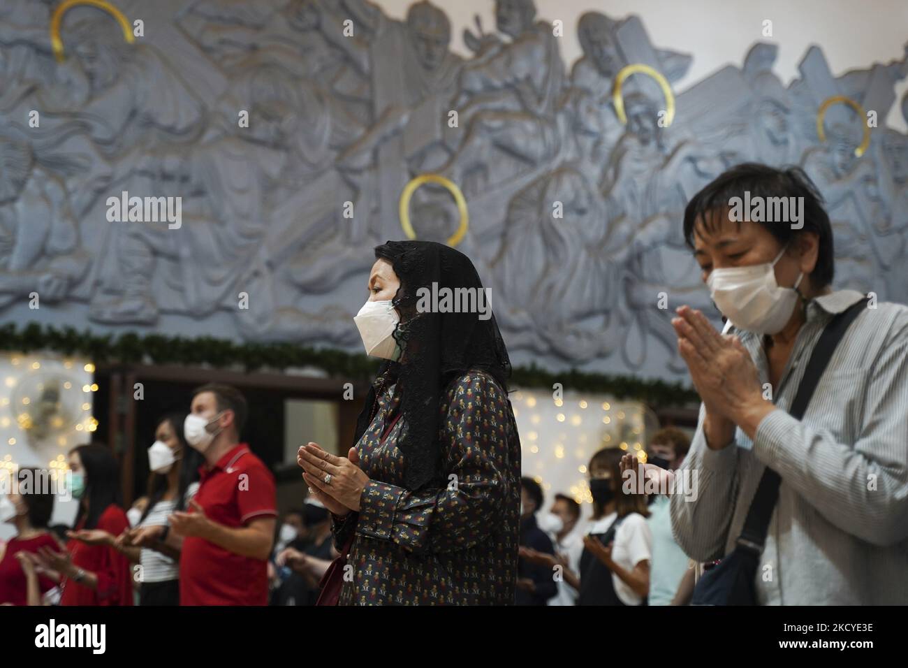 Thai and foreign Catholic church goers attend Christmas Eve at a church ...