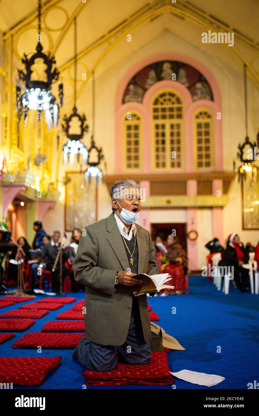 A Christianity follower recites the verses of the Bible inside a church ...