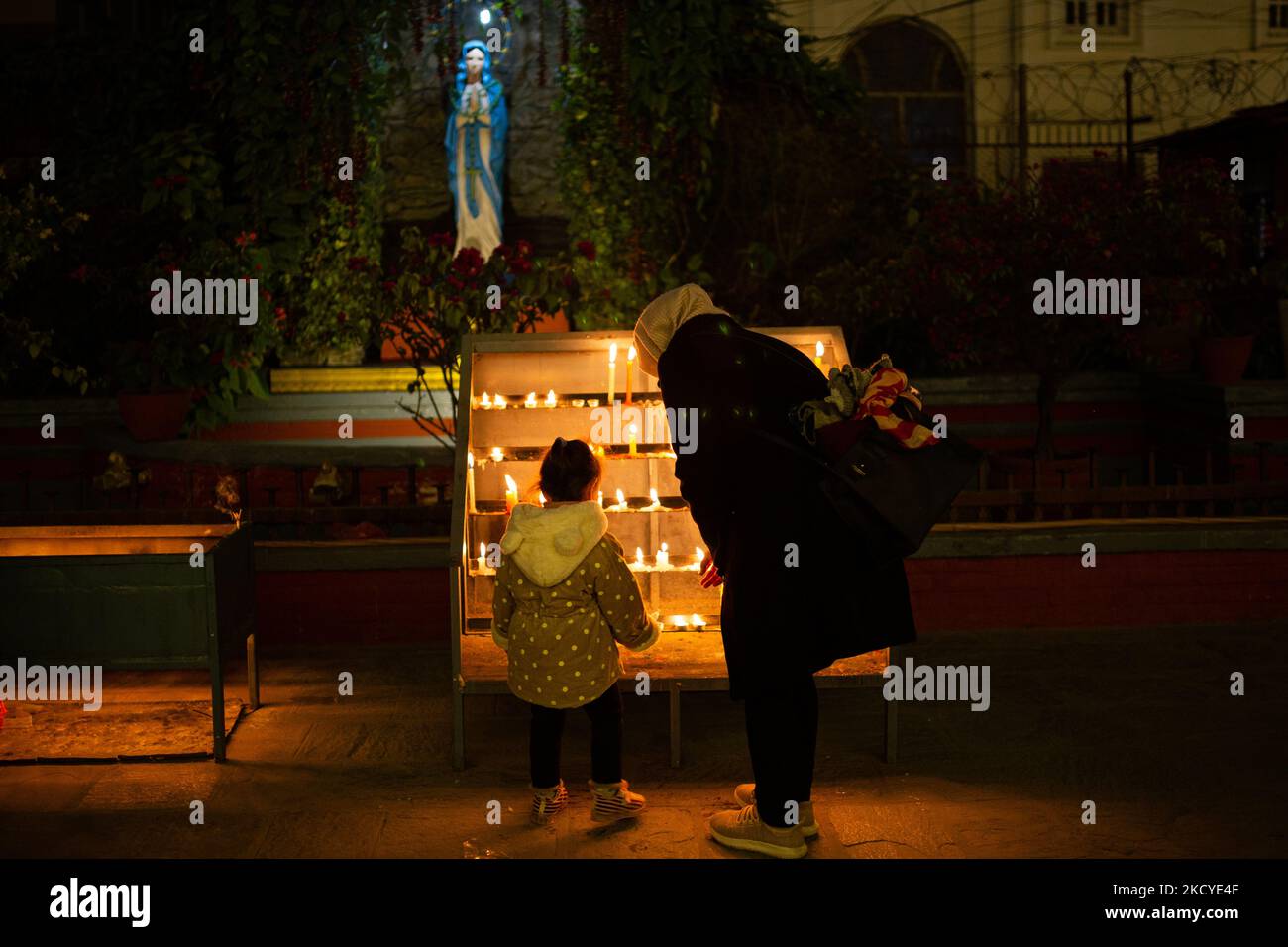 Christianity follower lights a candle on the premises of a church on ...