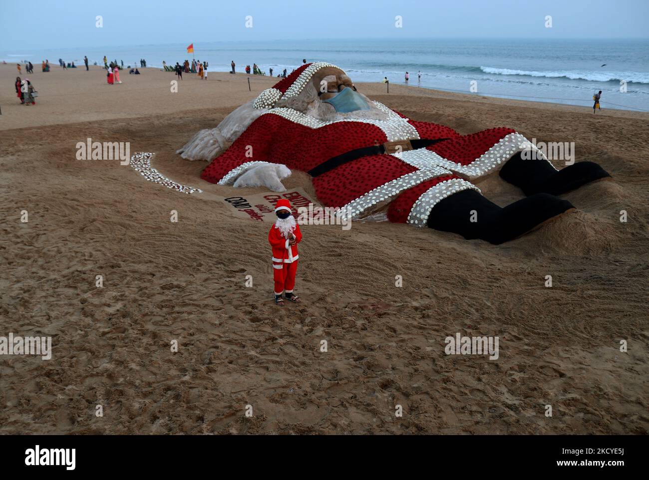 A sand sculpture of Santa Claus is seen on the eastern coast beach of ...