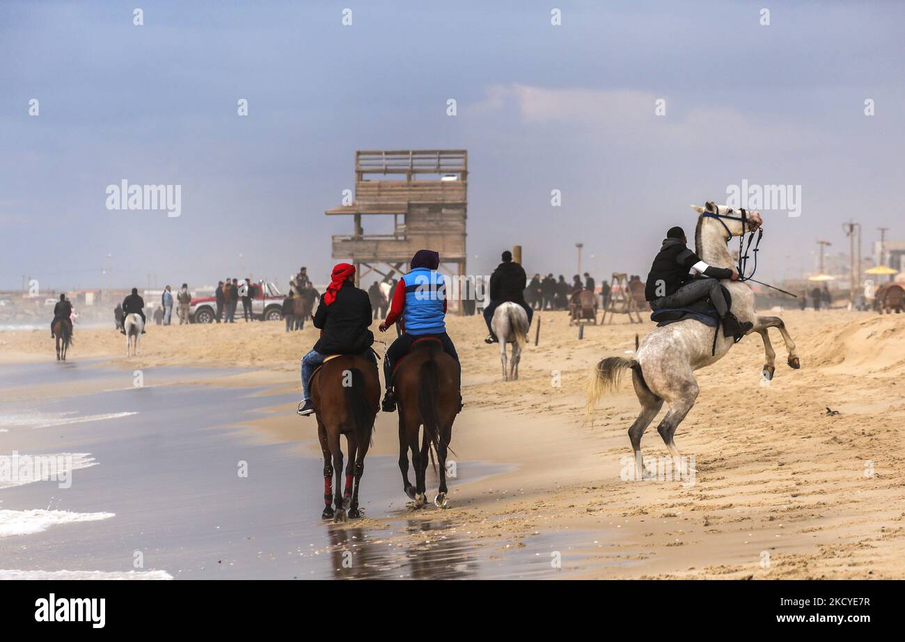 Palestinian men ride their horses in front of Gaza beach after heavy ...