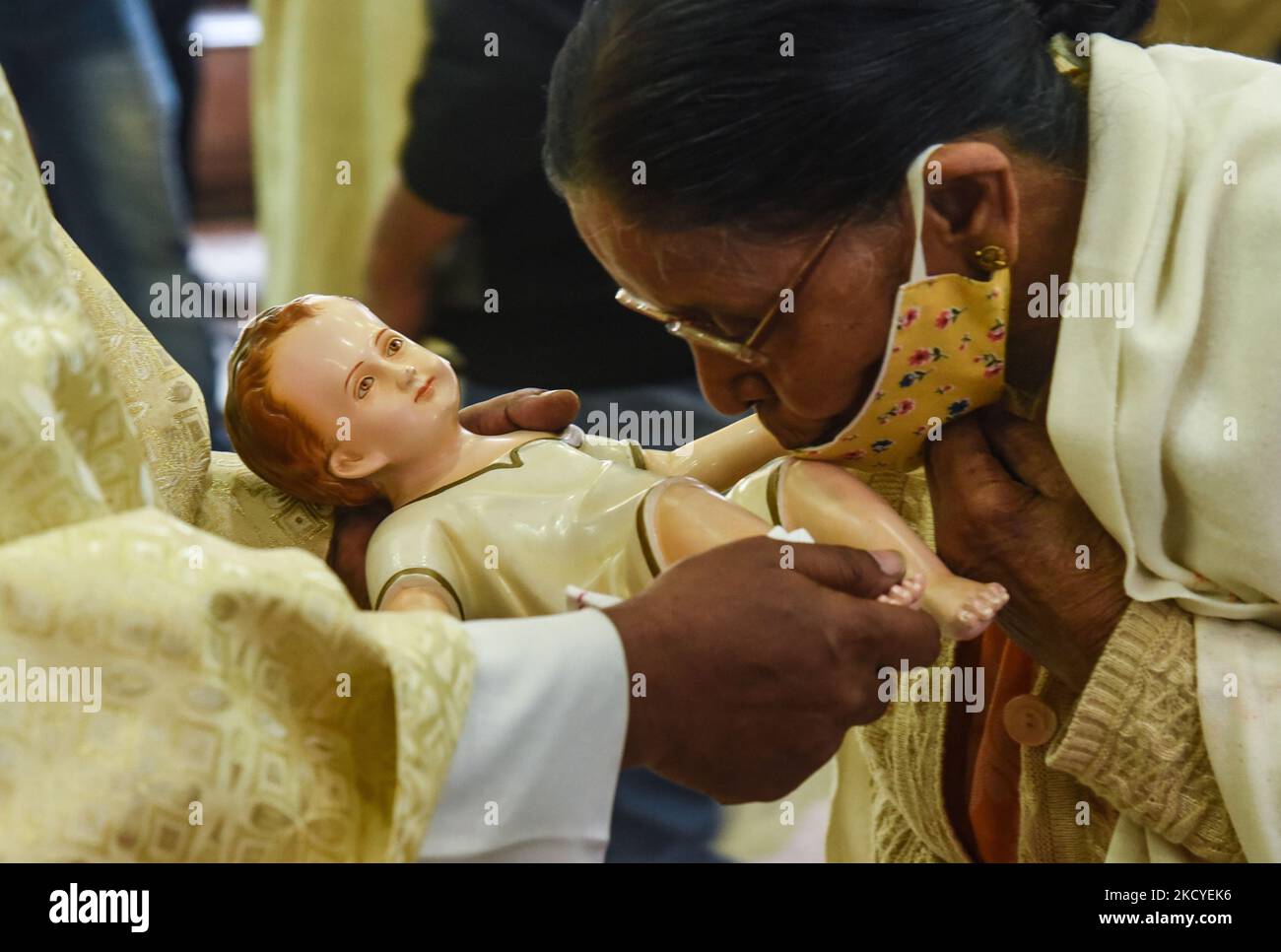 Devotee kisses the baby idol of Jesus Christ on the occasion of ...