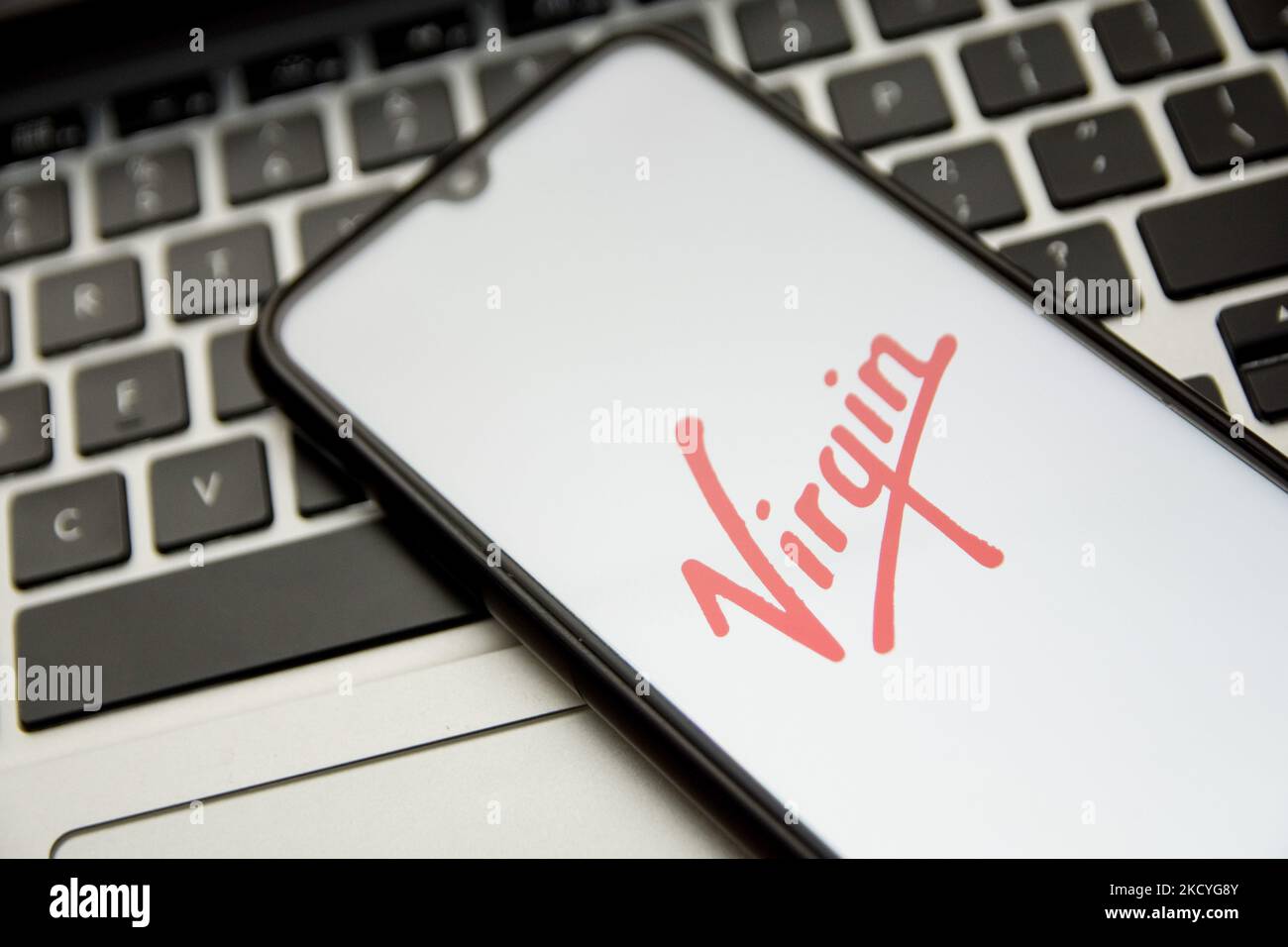 In this photo illustration a Virgin Group logo seen displayed on a ...
