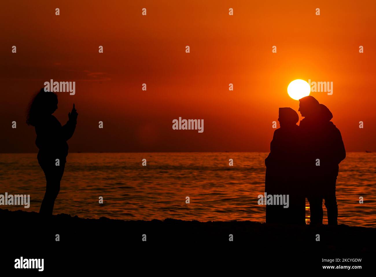A Palestinian girl takes a photo by cell phone for her sisters at the ...