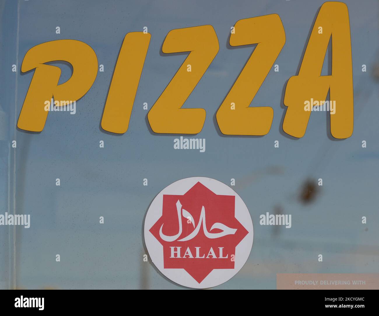 'Pizza Halal' written on the window of a takeout restaurant in Edmonton ...