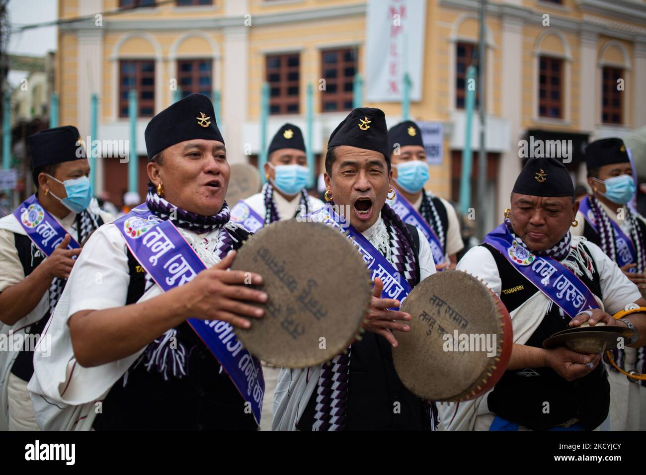 Nepalese people wearing traditional attire sing as they take part in ...