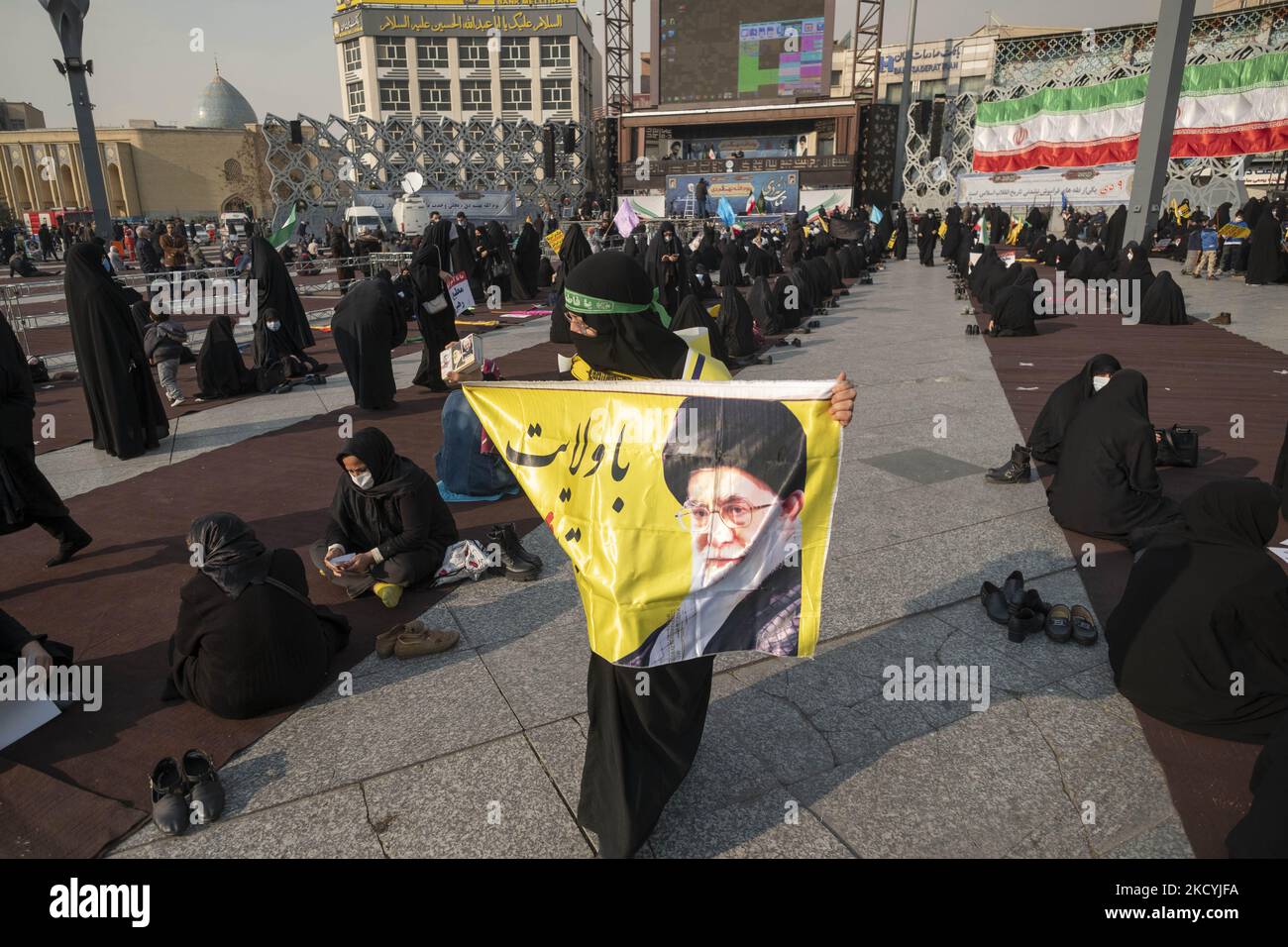 An Iranian veiled woman carries a banner with a portrait of Iran’s ...