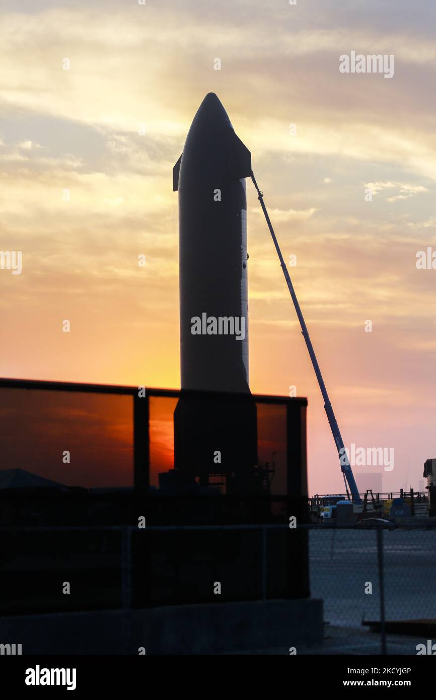 SpaceX's Starship 20 is seen through a mesh panel at sunset on December ...