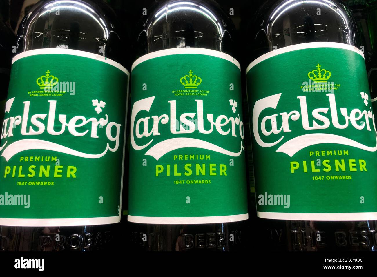 Carlsberg logos are seen on beer bottles at the shop in Krakow, Poland ...