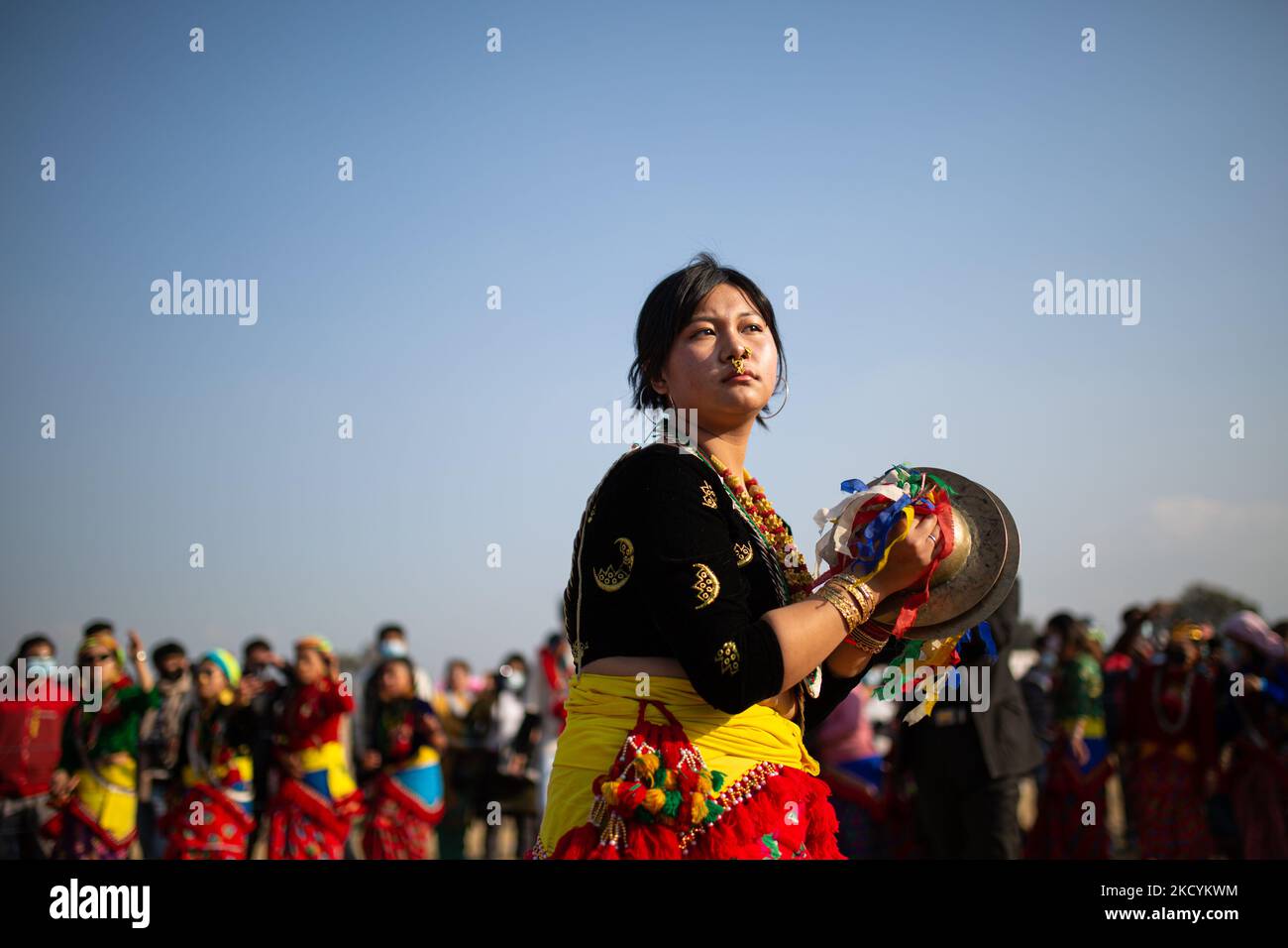 A girl from the Kirat community plays a traditional instrument during ...