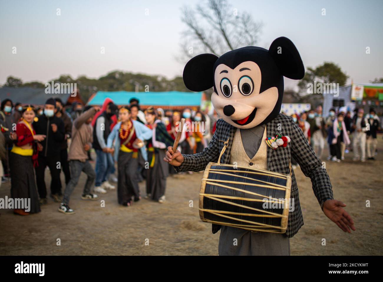 A mascot plays a traditional instrument during the Sakela festival in ...
