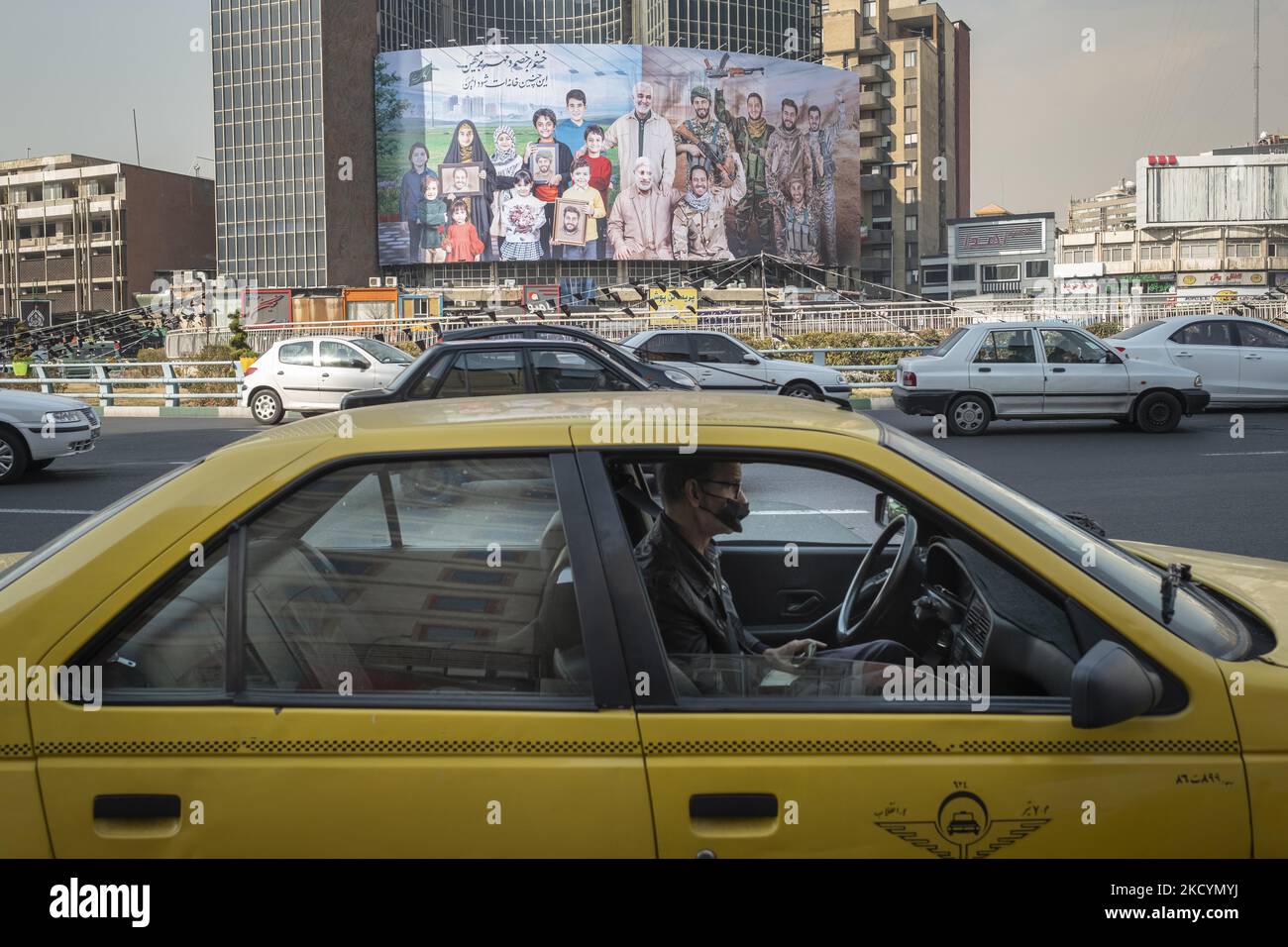 An Iranian yellow cab driver sits at his vehicle which is parked on a ...