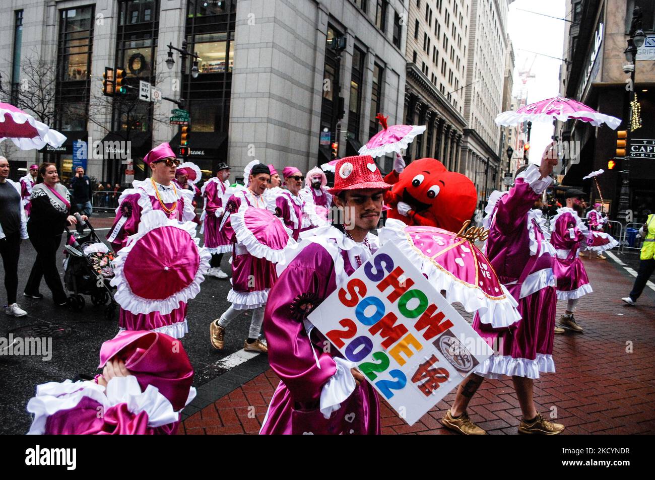A mummer carries a sign calling for 2022 to be a year of LOVE in Philly ...