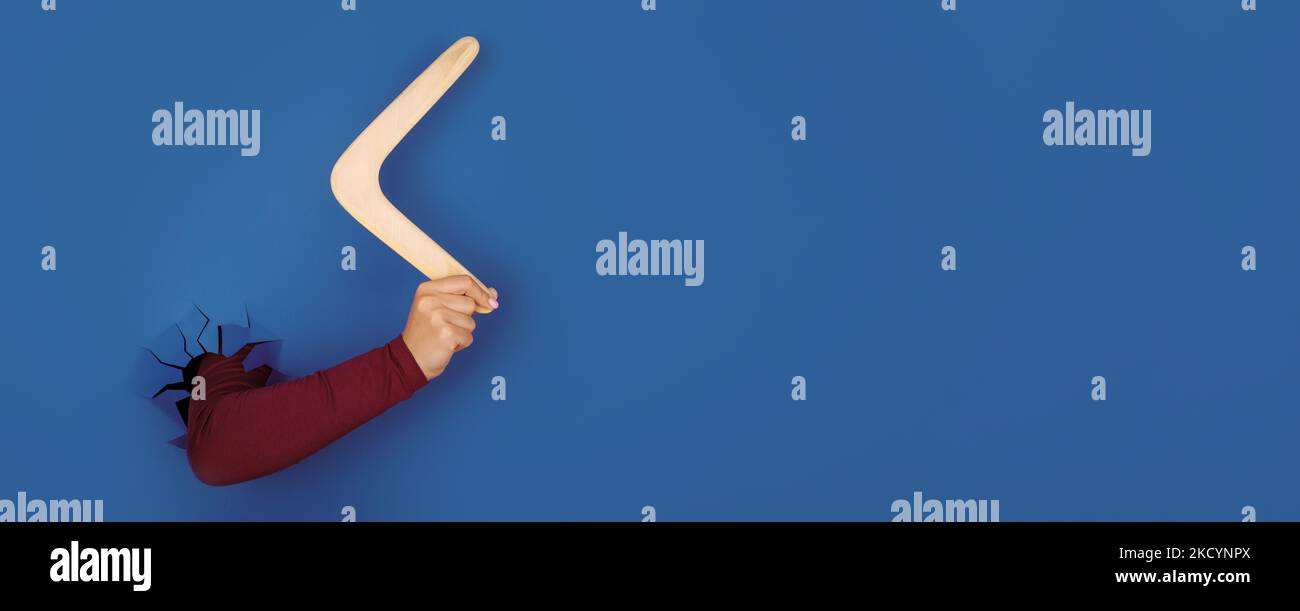 hand holding boomerang over blue background, panoramic layout Stock ...