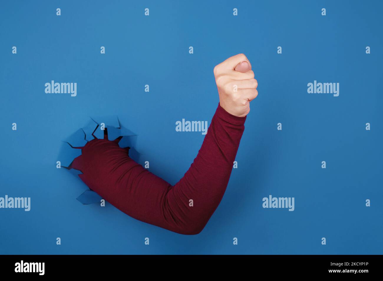 Hand showing the fig sign over blue background Stock Photo - Alamy
