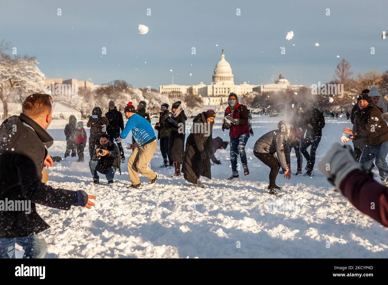 People engage in a huge snowball fight on the National Mall after an ...