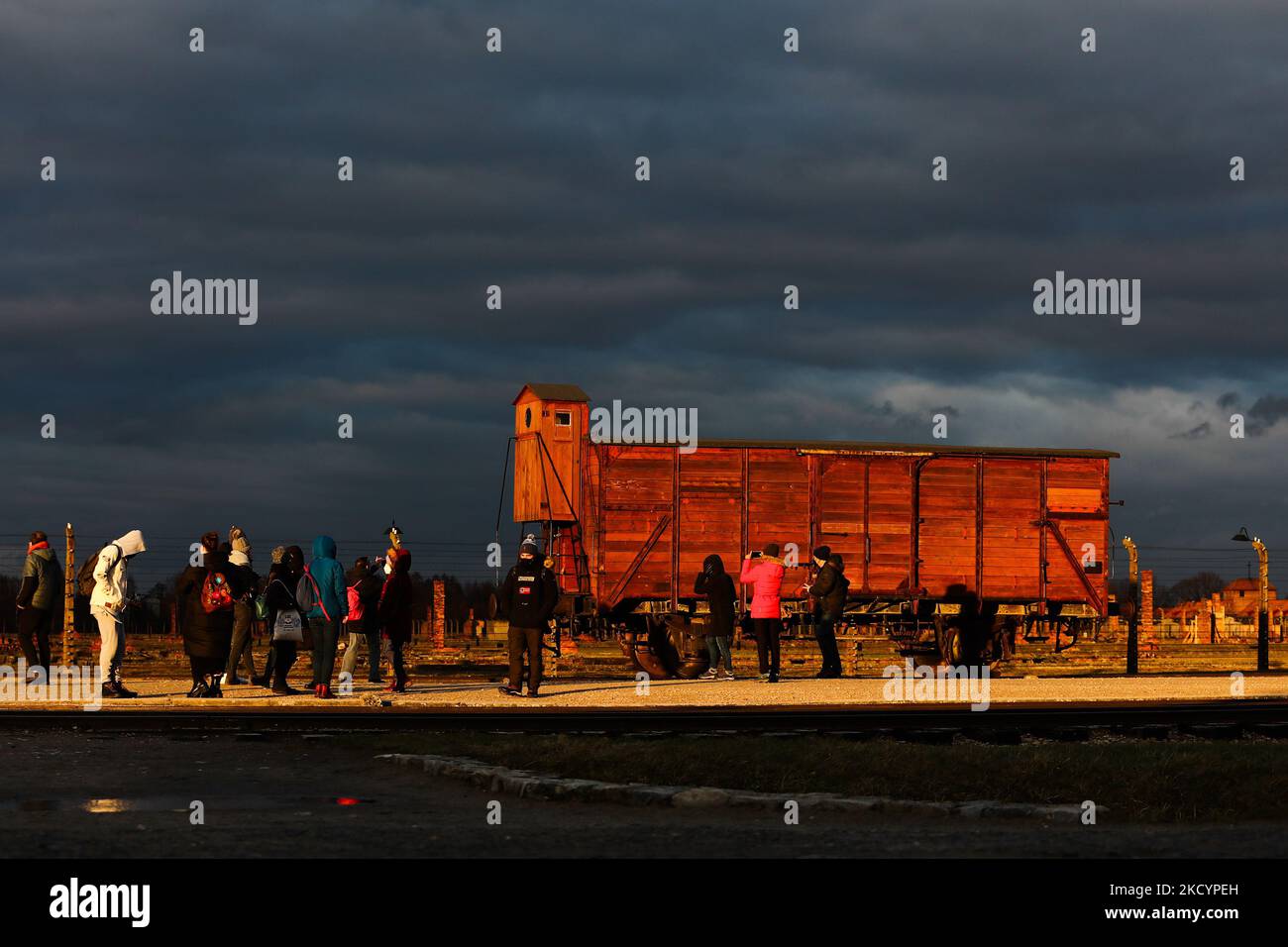Visitors near a box car at the former Nazi German concentration camp ...