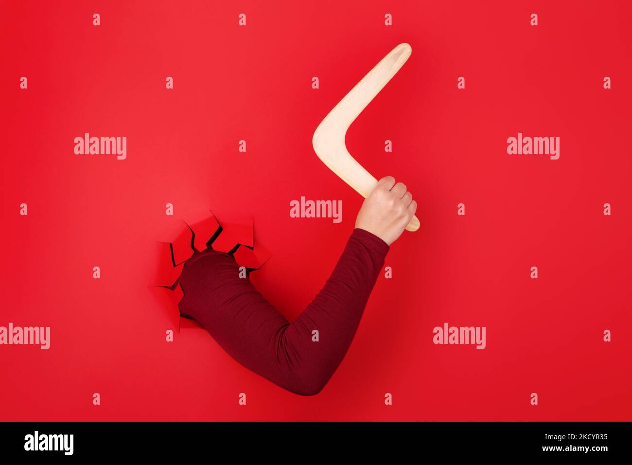 boomerang in hand over red background Stock Photo - Alamy