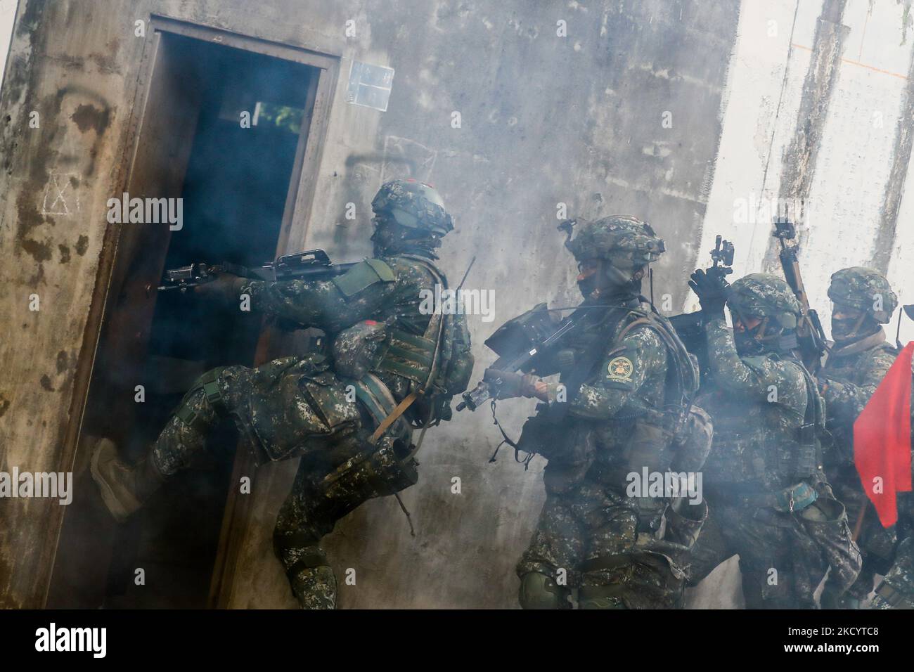 Soldiers break a door for an assault against enemies , during an Army ...