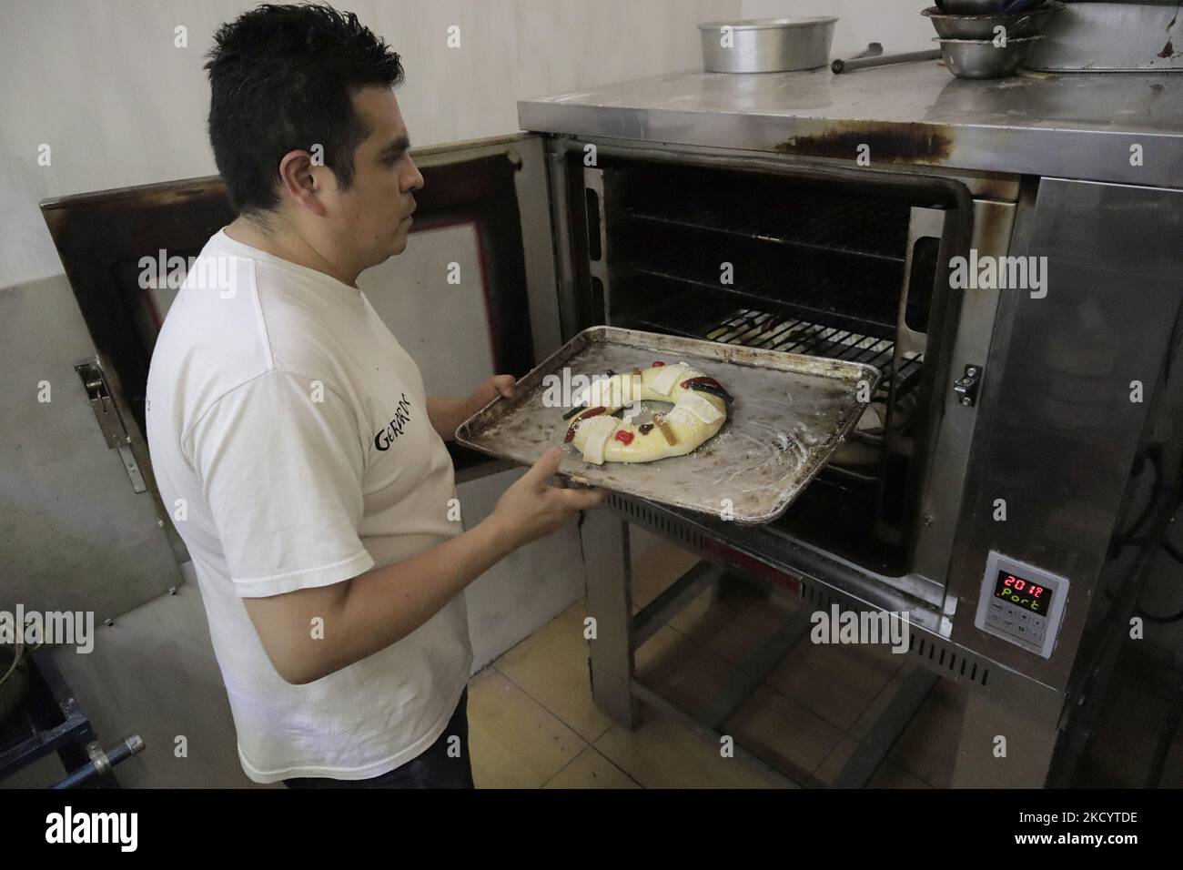 A baker bakes dough for the elaboration of Roscas de Reyes in a bakery ...