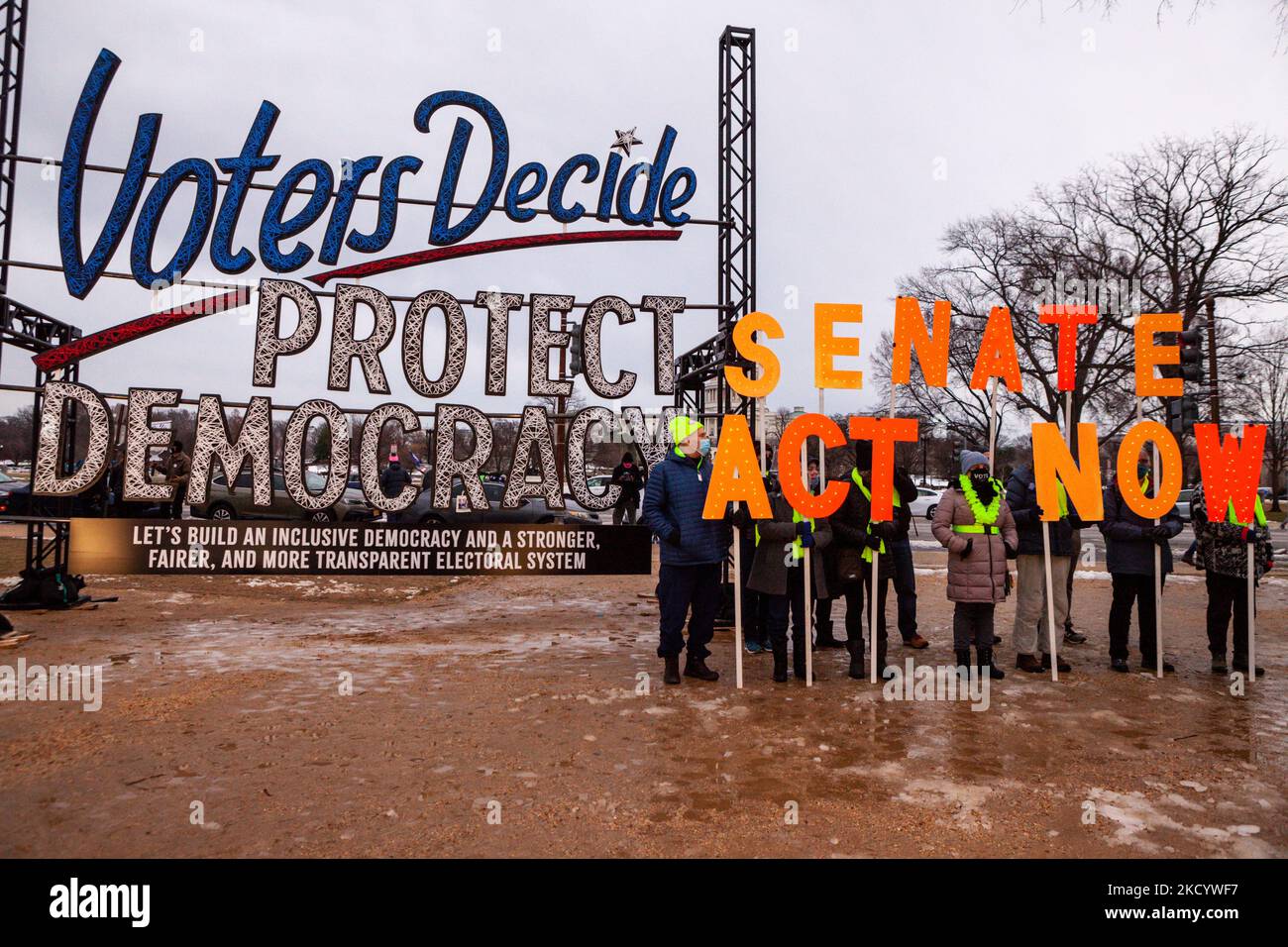 Volunteers display signs urging the Senate to protect voting rights ...