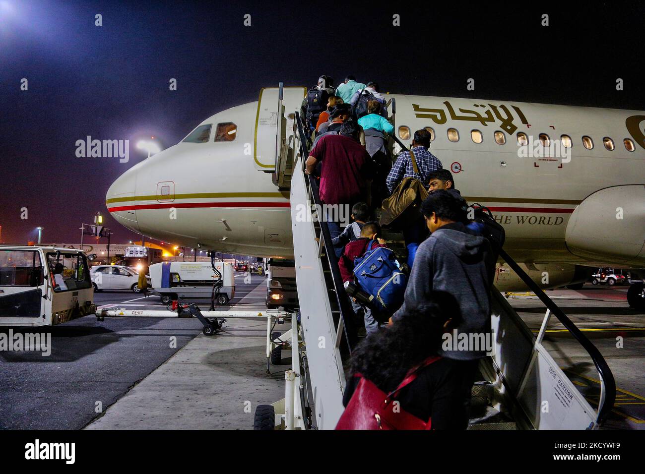 Passengers board an Etihad Airways airplane at Abu Dhabi International ...