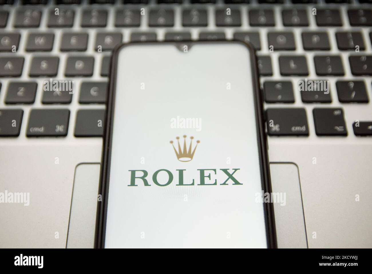 In this photo illustration a Rolex logo seen displayed on a smartphone ...