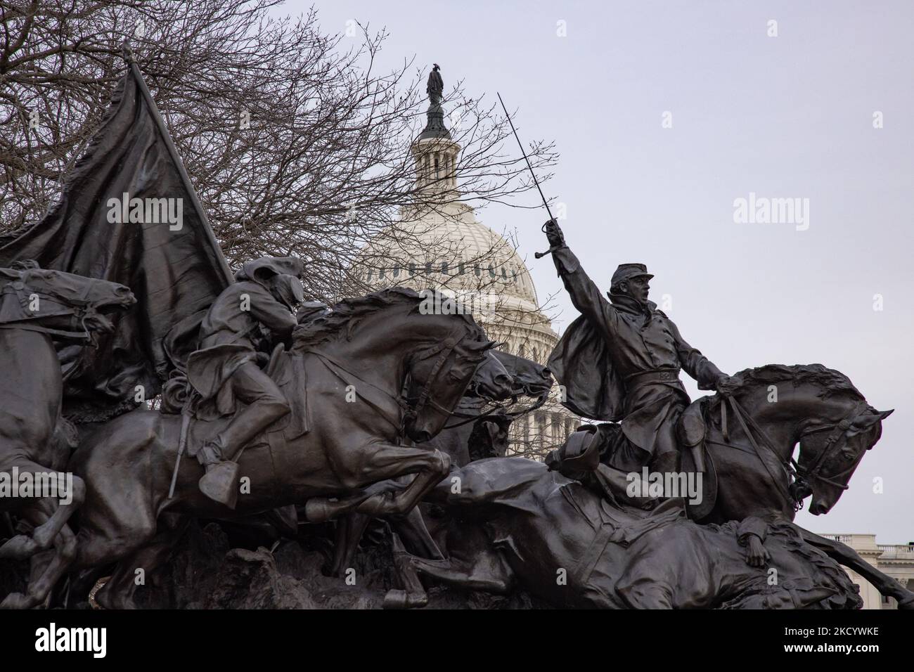 The U.S. Capitol dome is seen beyond a soldier depicted in a statue at ...