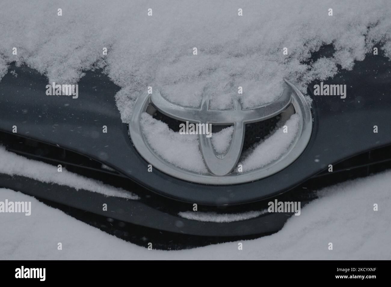 Toyota logo seen on a Toyota car covered with snow in downtown Edmonton ...