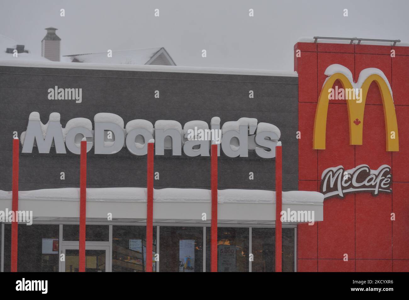 McDonald's fast food restaurant covered with fresh snow in the central ...