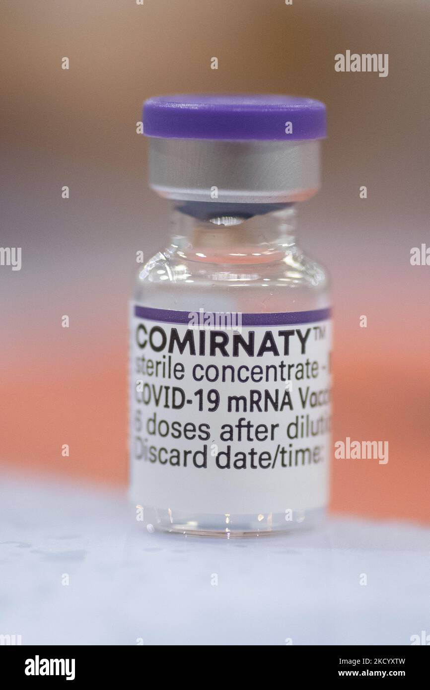 Close up at the vial with the inscription Comirnaty, mRNA etc, the ...