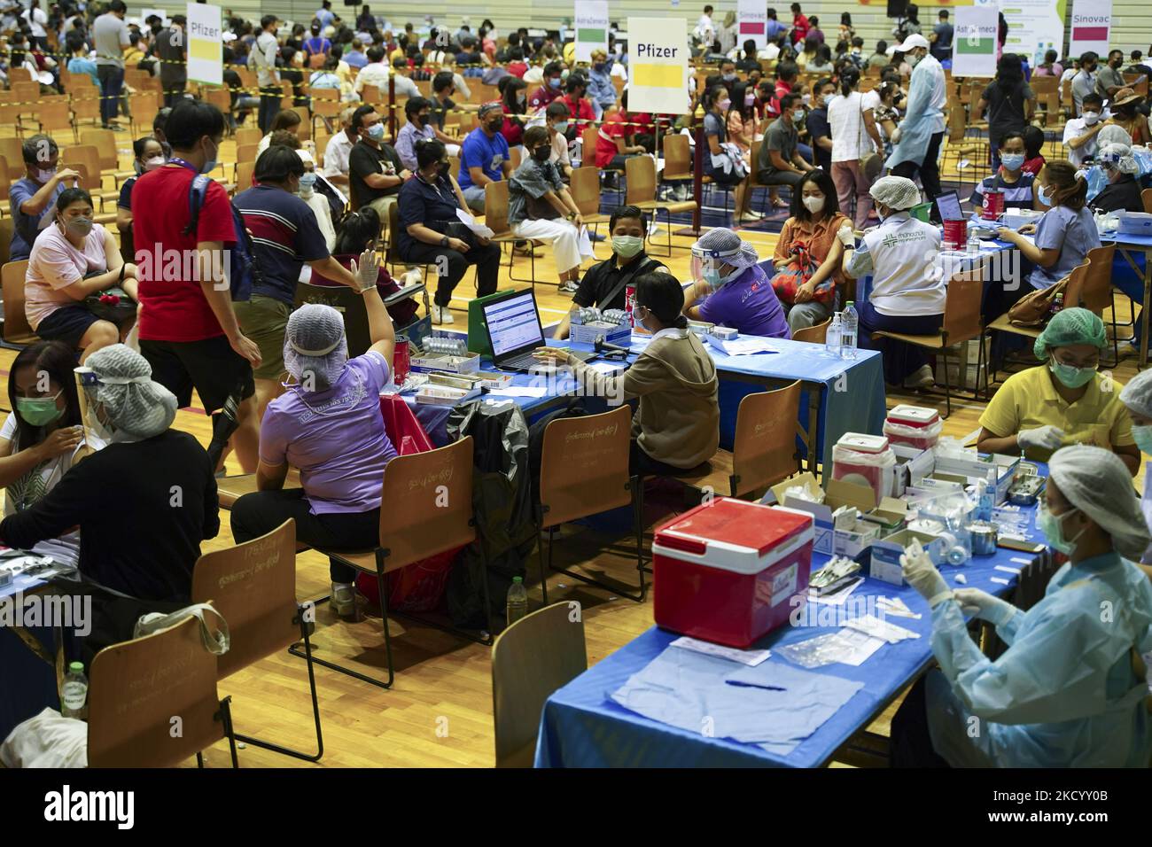 People receive doses of the Pfizer COVID-19 vaccine at a vaccination ...