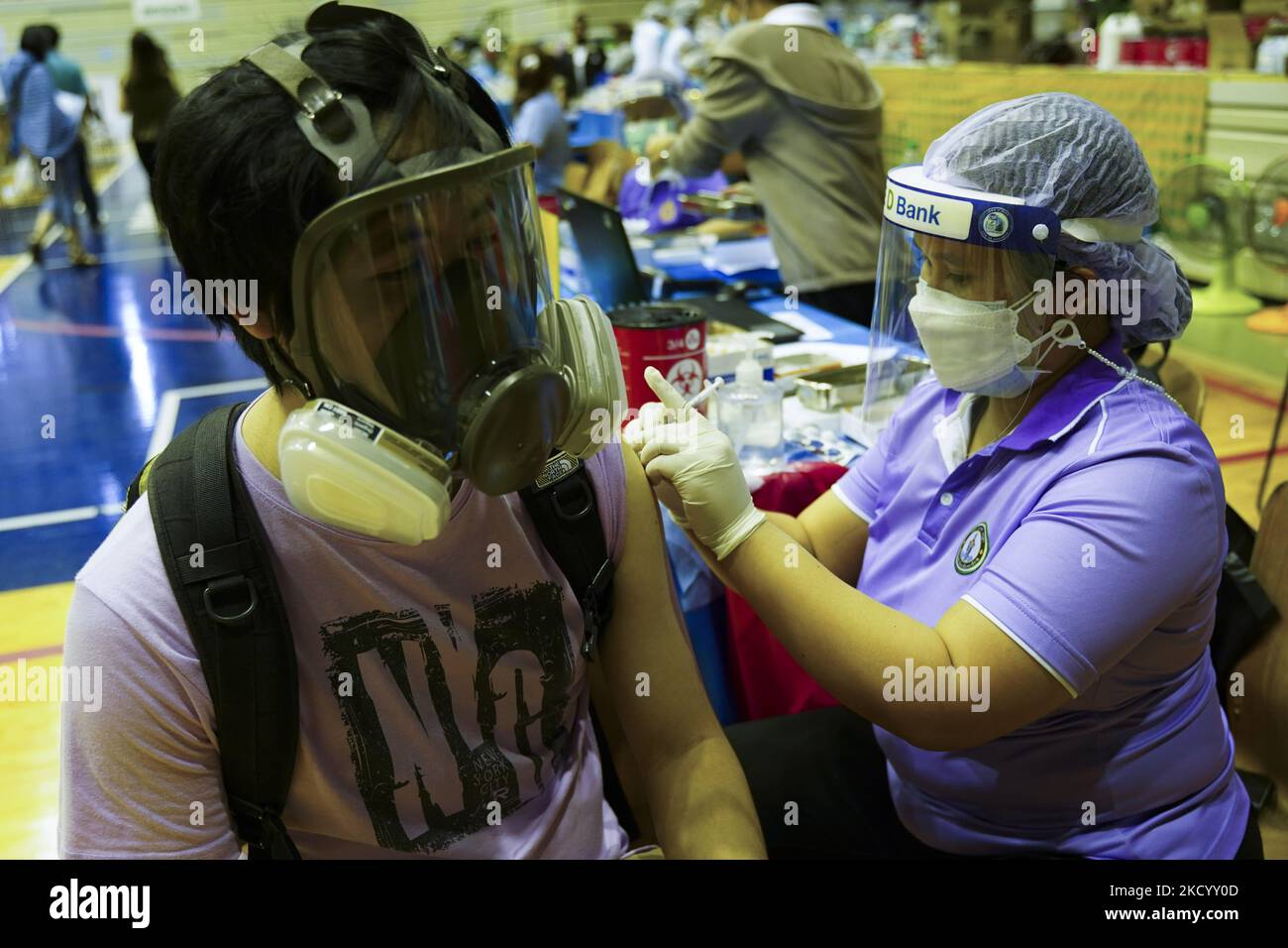 People receive doses of the Pfizer COVID-19 vaccine at a vaccination ...
