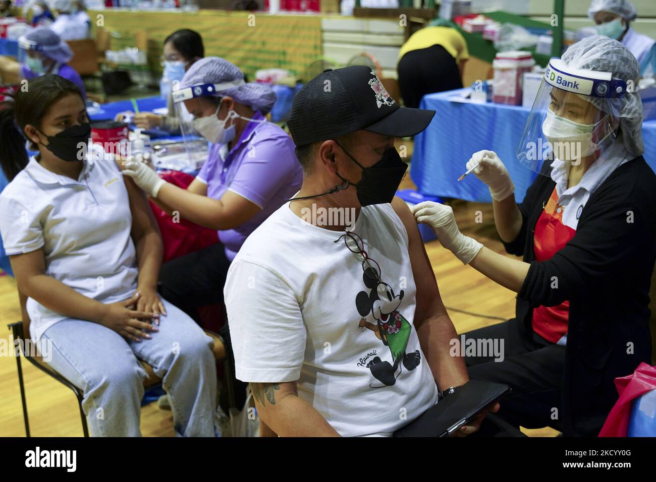 People receive doses of the Pfizer COVID-19 vaccine at a vaccination ...