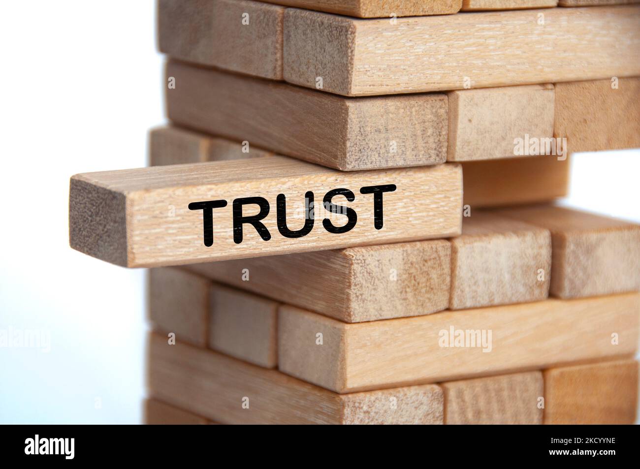 Trust text on a wooden block. Trusting each other to achieve common ...