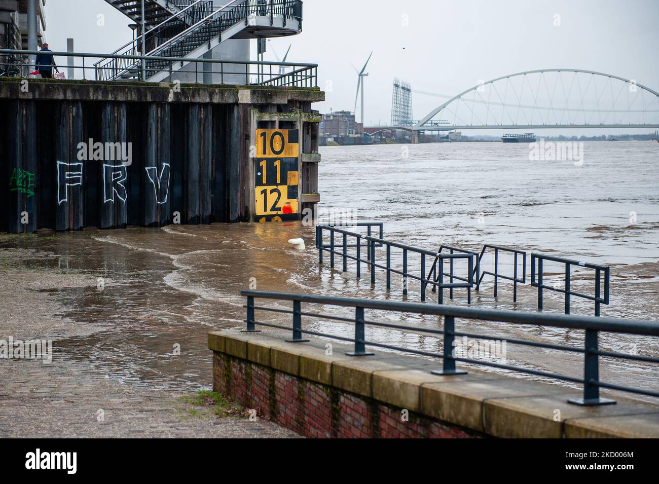 A view of the sign that marks the high levels water on the river Waal ...