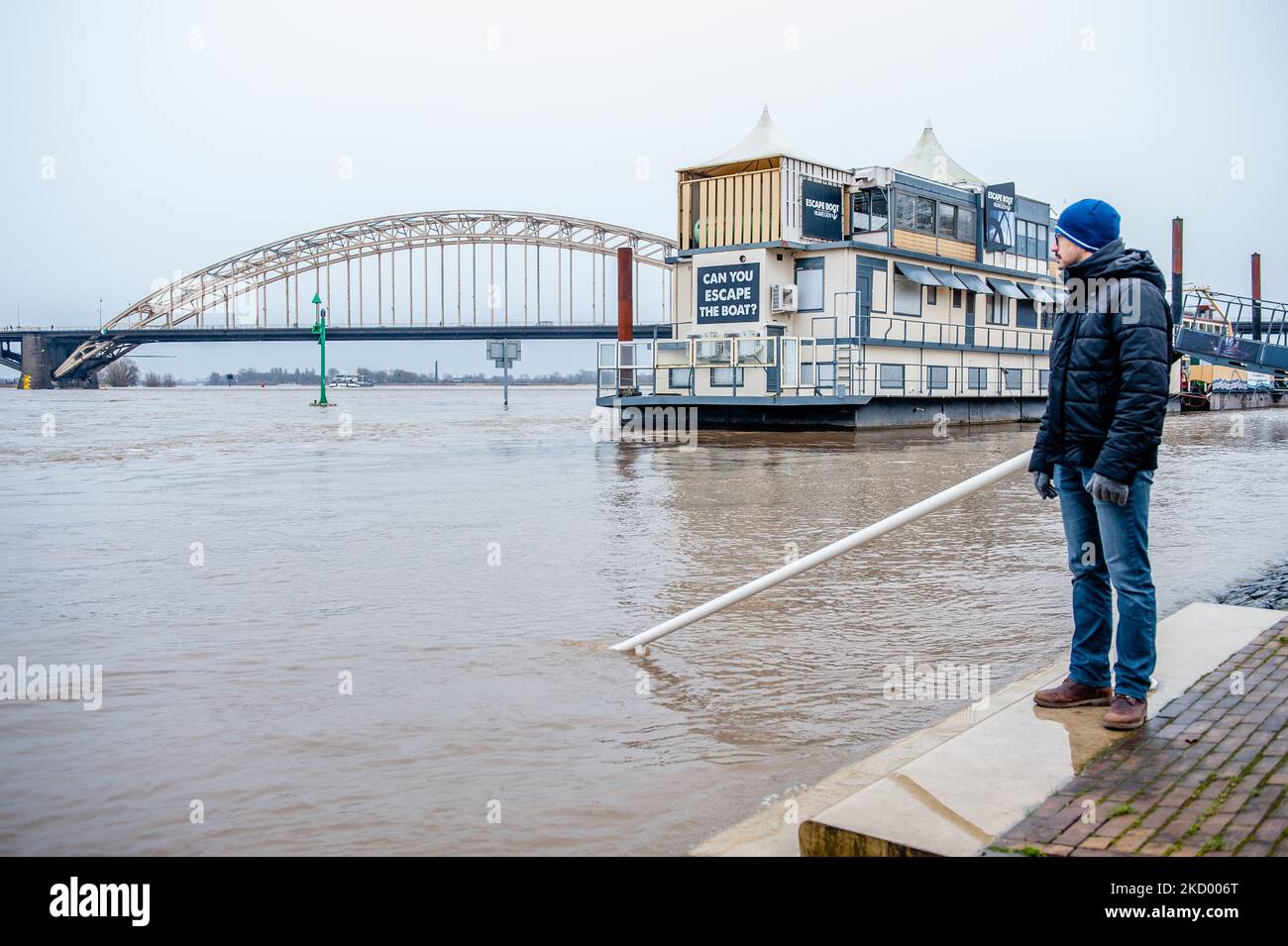 A man is watching the high water levels on the river Waal, in Nijmegen ...