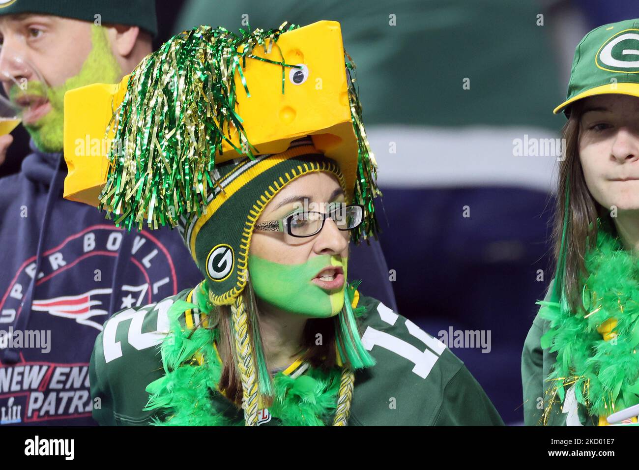 A fan in Green Bay Packers attire looks on from the stands during an ...