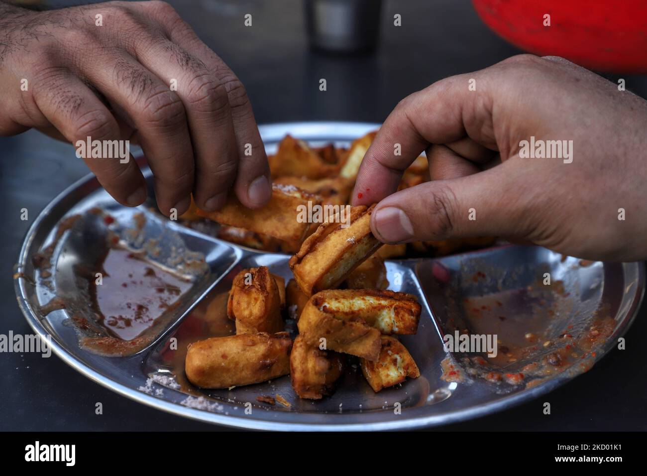 Visitors enjoy Paneer Pakora (Cottage Cheese Fritters) at a Tea Stall ...
