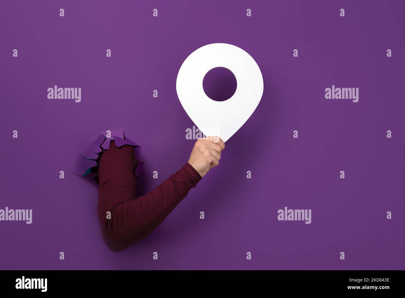 hand holding pin over purple background Stock Photo - Alamy