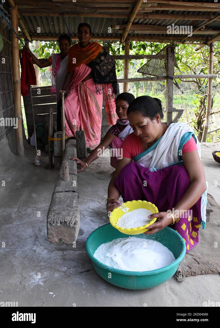 Women prepare rice by at traditional 'dhekis' for Bhogali Bihu festival ...