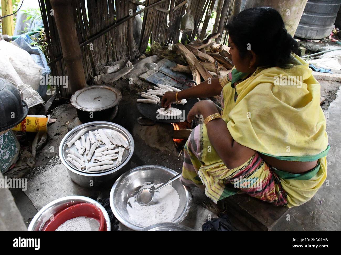 An Assamese woman prepares 'pitha', a traditional sweet, ahead of ...