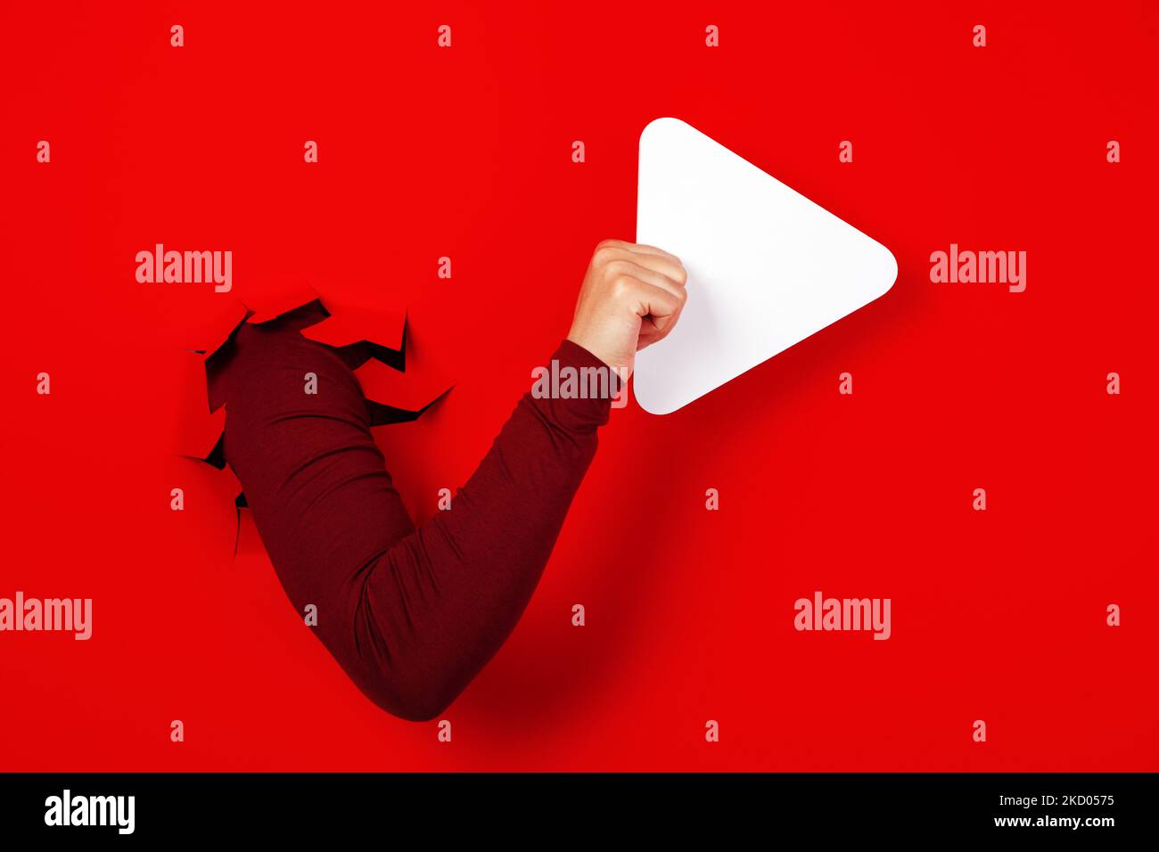 Play button in hand over red background Stock Photo - Alamy