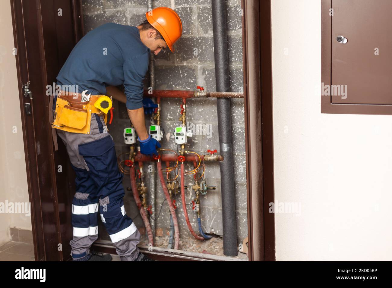 Technician inspecting heating system in boiler room Stock Photo - Alamy