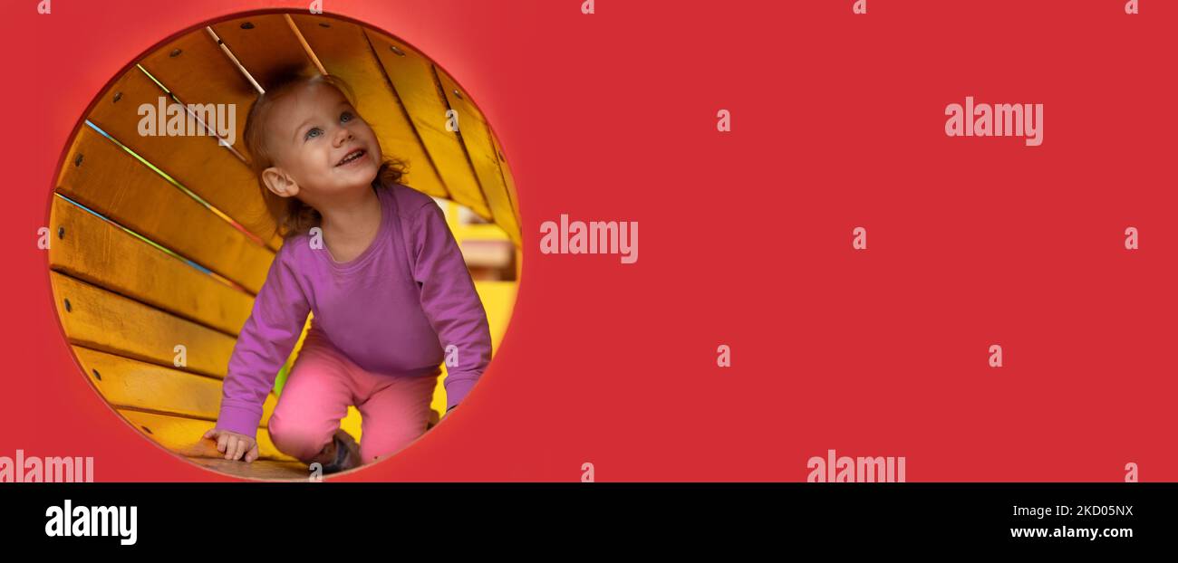 little girl playing in the playground, panoramic layout Stock Photo - Alamy