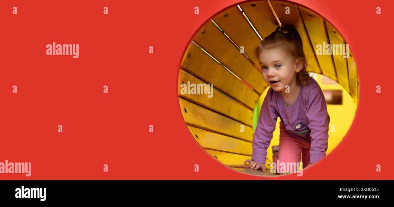 little girl playing in the playground, panoramic layout Stock Photo - Alamy
