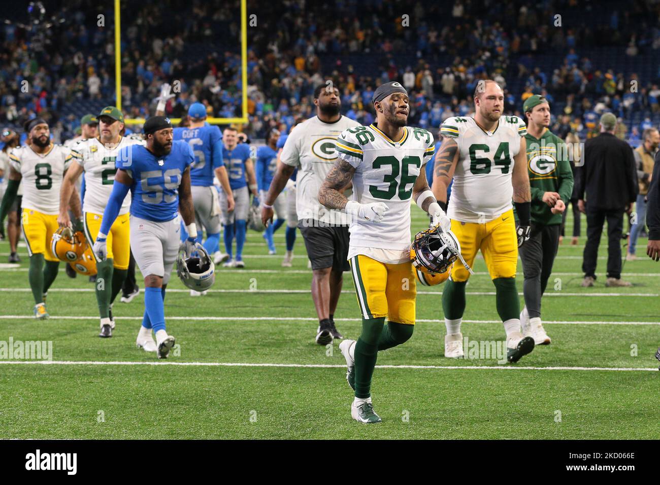 Green Bay Packers and Detroit Lions players walk off the field after ...