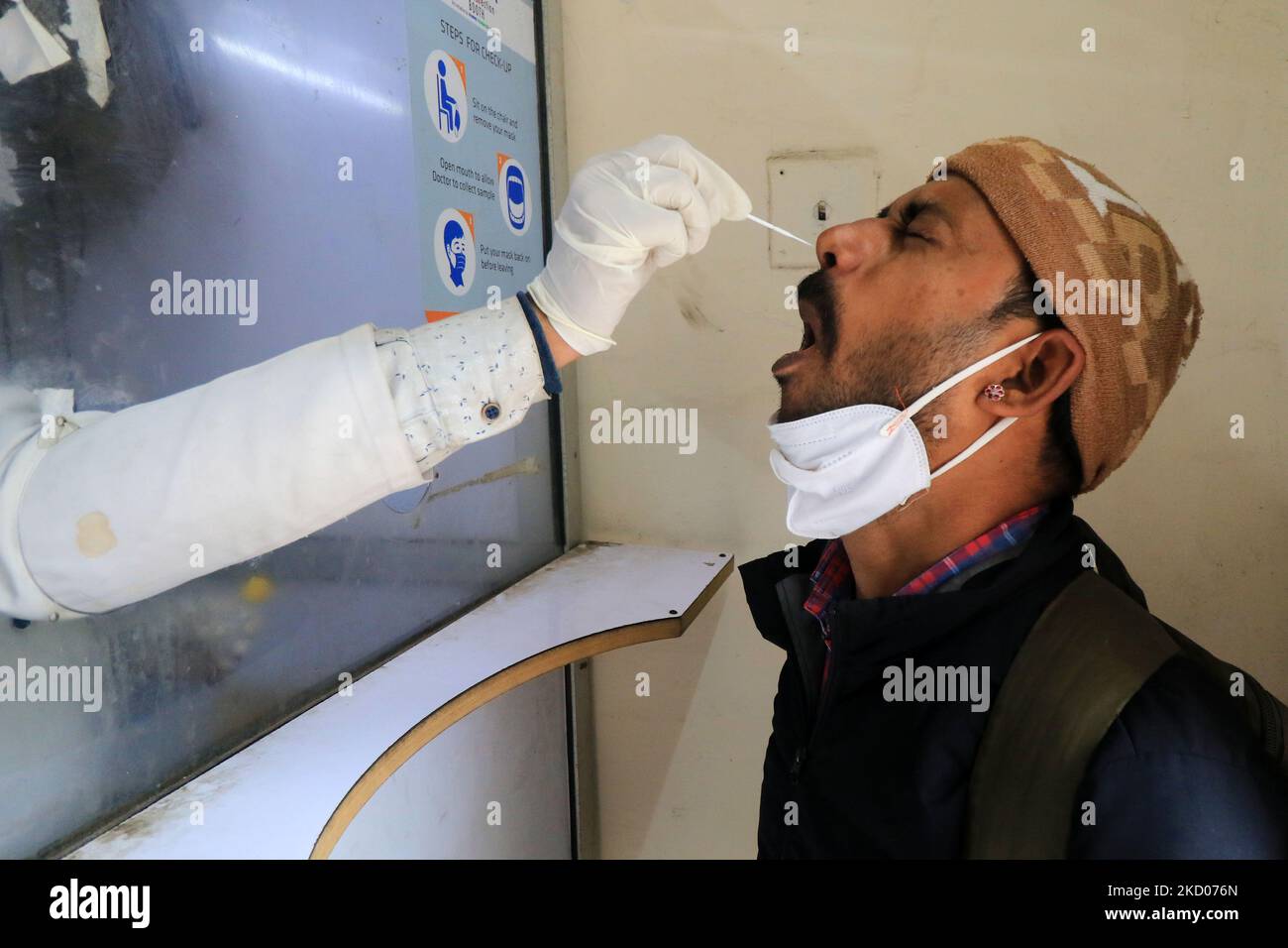 A health official take a swab sample for the COVID-19 tests, amid in ...