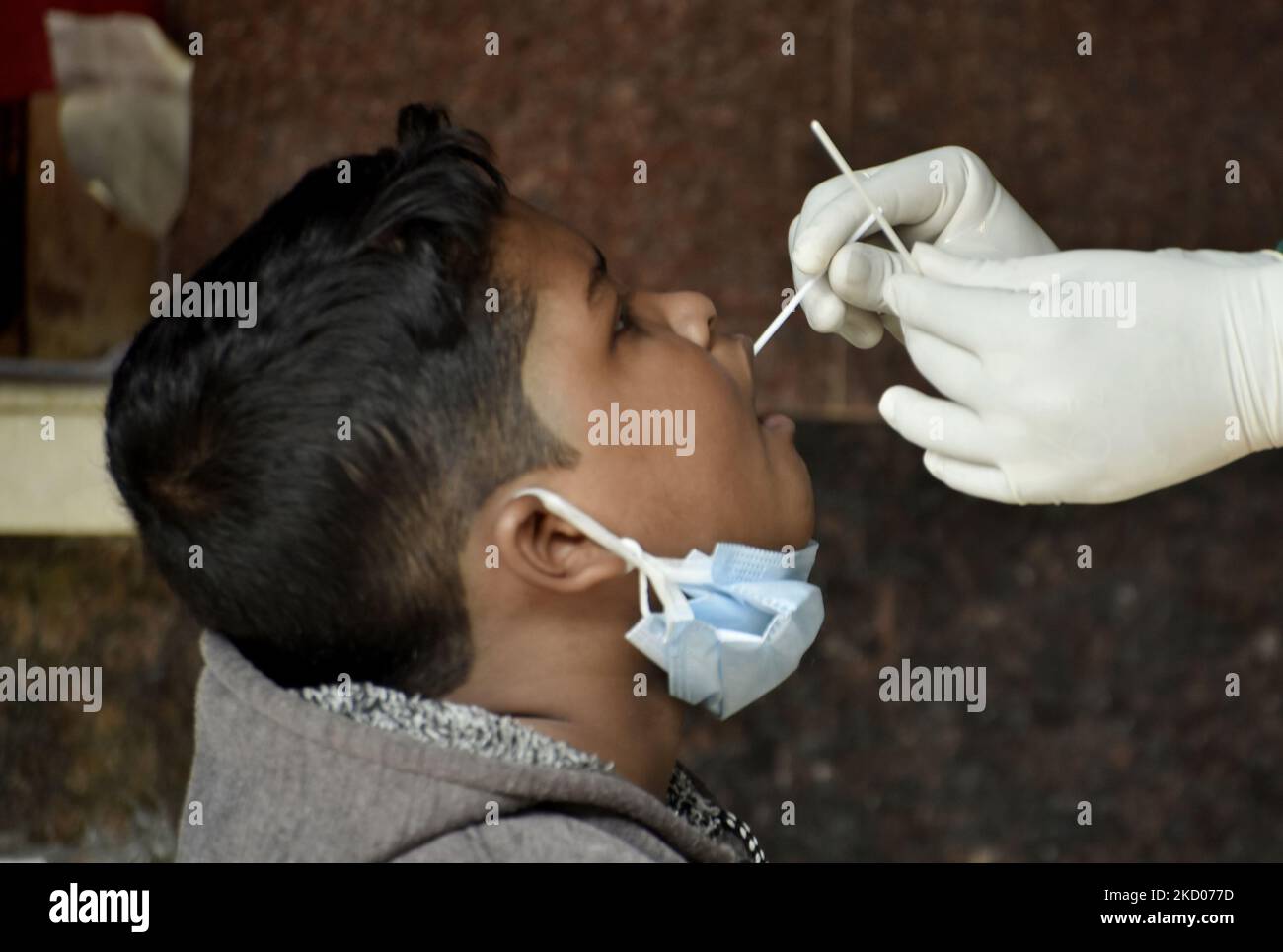 A child reacts during a swab test amid coronavirus emergency in Kolkata ...