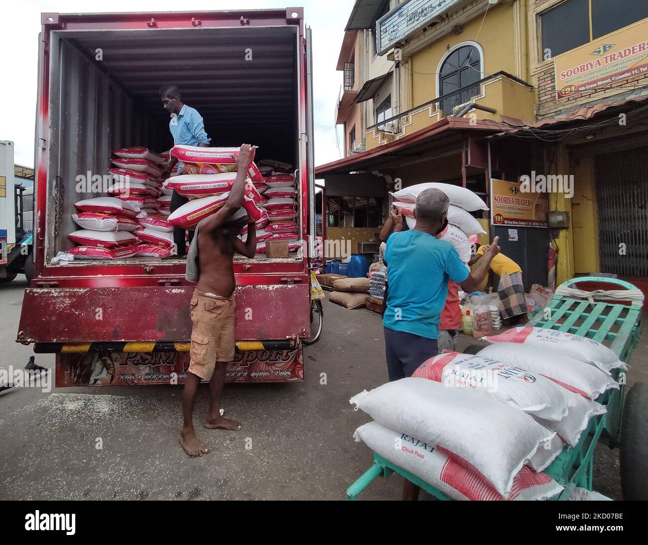 Sri Lankan laborers wearing facemasks unload rice at Colombo, Sri Lanka ...